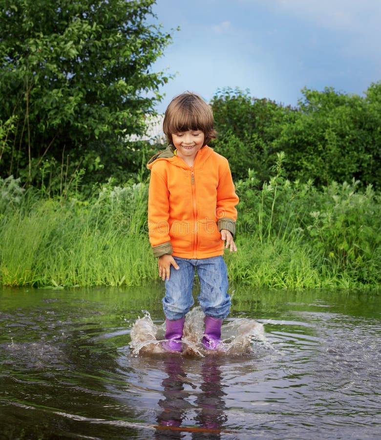 Child Jumping in Mud Puddle Stock Image - Image of environment, healthy ...