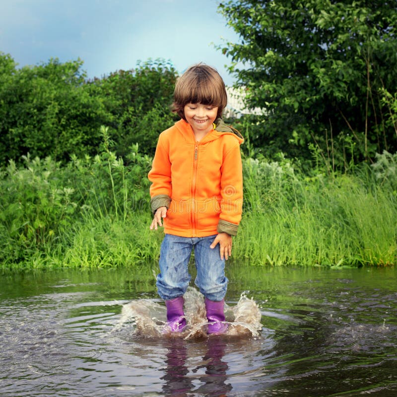 Little Happy Girl Jumping in Puddle Stock Photo - Image of natural ...