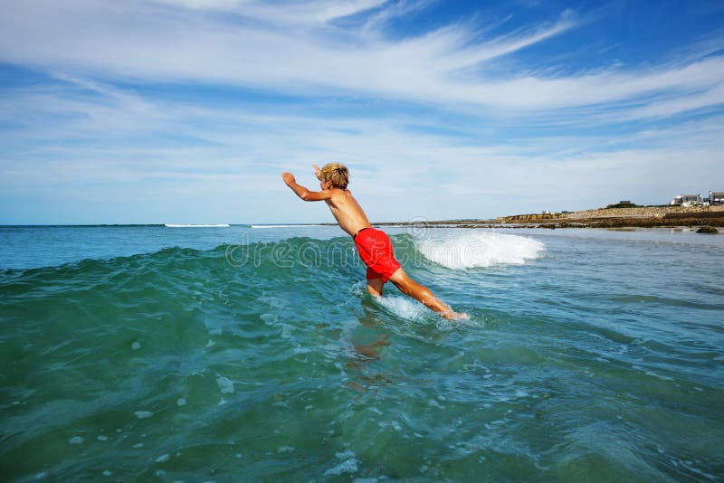 Boy Jump Running into Ocean Wave on the Summer Beach Stock Photo ...