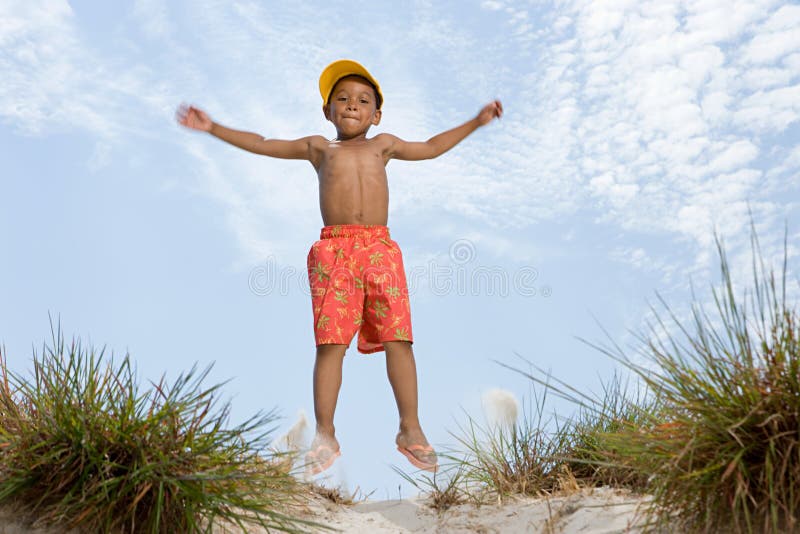 Boy jumping stock photo. Image of childhood, beach, enjoyment - 62562682