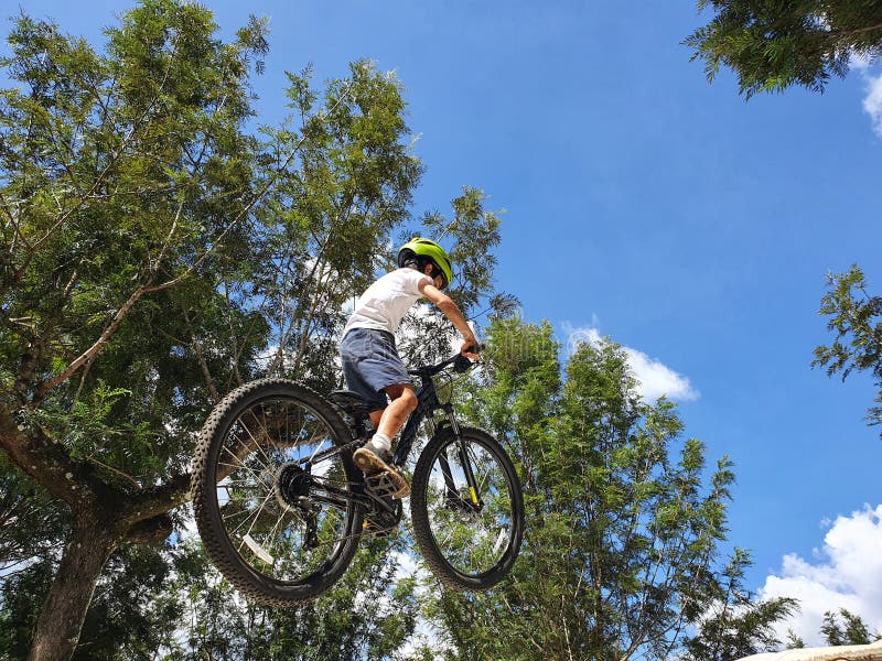 A Boy Jumping with His Mountain Bike Stock Image - Image of trail, jump ...