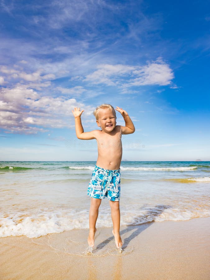 Boy jumping on the beach stock photo. Image of healthcare - 94651502