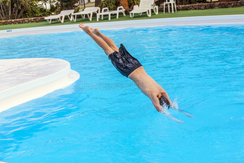 Boy Jumping in the Blue Pool Stock Photo - Image of beauty, caucasian ...