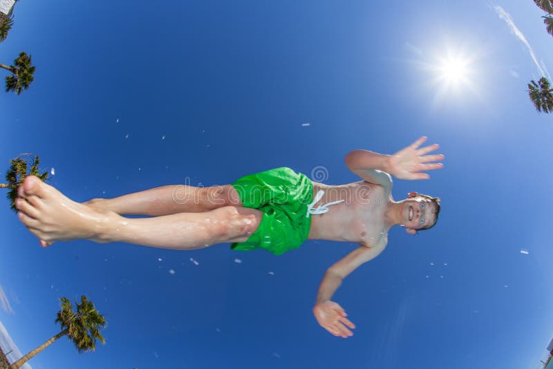 Teen Boy Jumping in the Blue Pool Stock Photo - Image of board, male ...