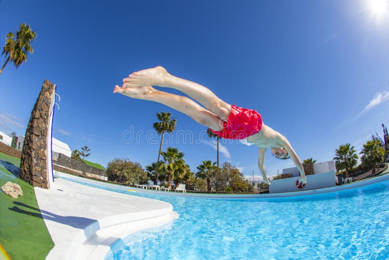 Teen Boy Jumping in the Blue Pool Stock Photo - Image of board, male ...