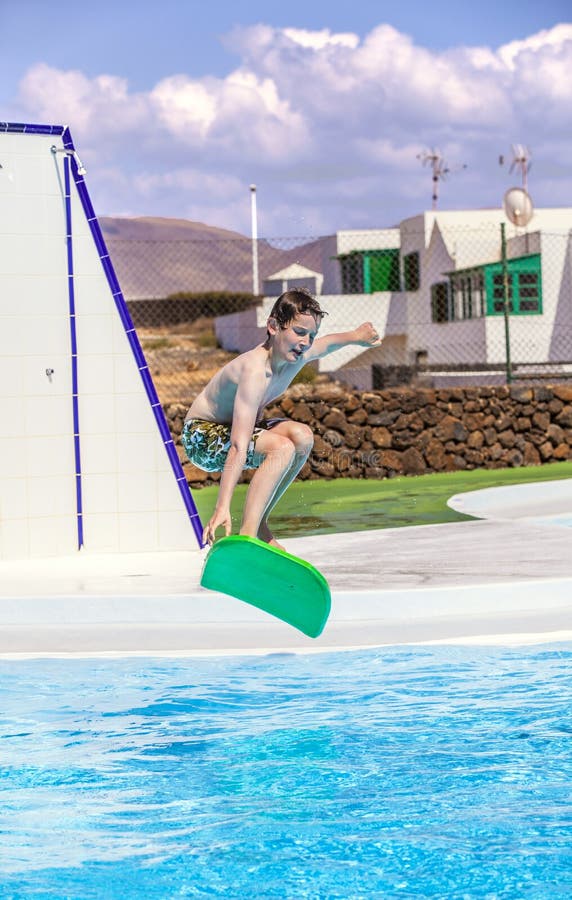Boy Jumping in the Blue Pool Stock Photo - Image of handsome, beautiful ...