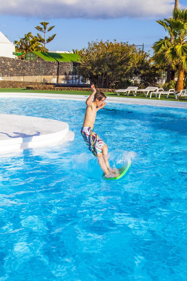 Boy Jumping in the Blue Pool Stock Image - Image of activity, board ...