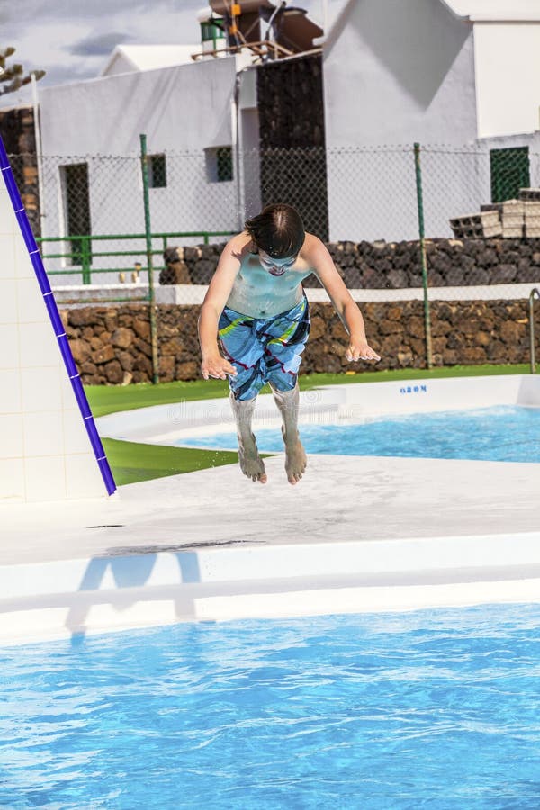 Boy Jumping in the Blue Pool Stock Photo - Image of outdoor, person ...