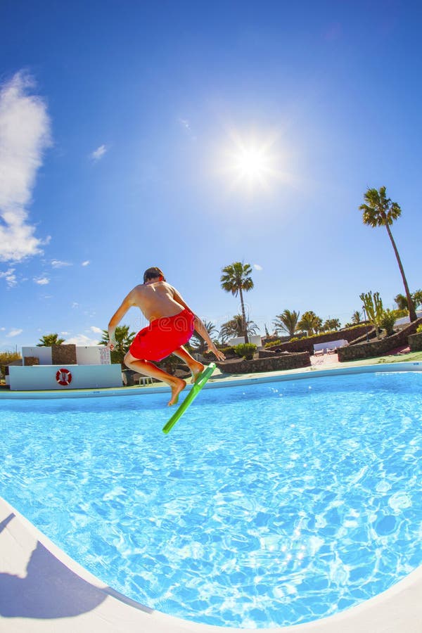 Boy Jumping in the Blue Pool Stock Photo - Image of handsome, club ...