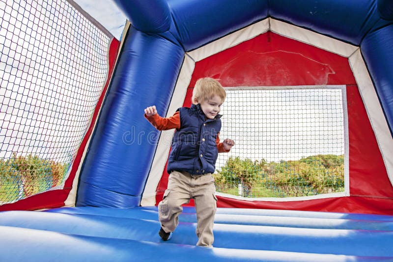 Kids Playing on an Inflatable Slide Bounce House Stock Photo - Image of ...