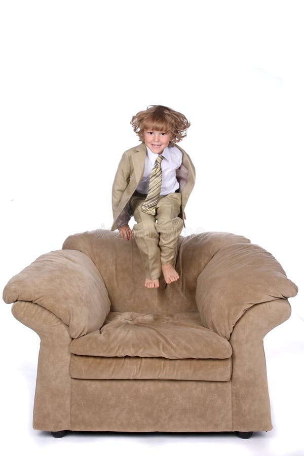 Boy jumping on chair stock photo. Image of handsome, chair - 5943574