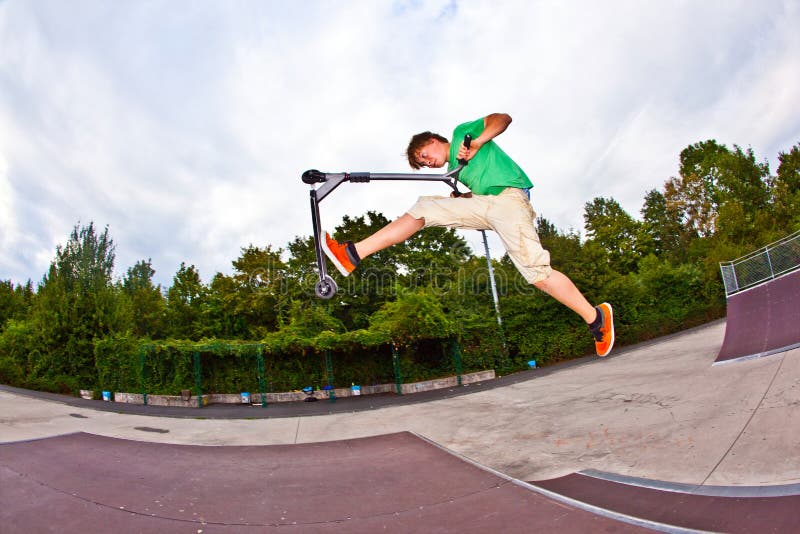 Boy Jumping with His Scooter Stock Photo - Image of enthusiastic ...
