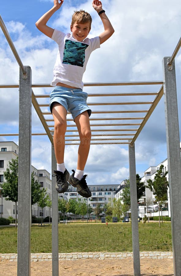 Boy Jumping from the Horizontal Bar Stock Image - Image of short ...