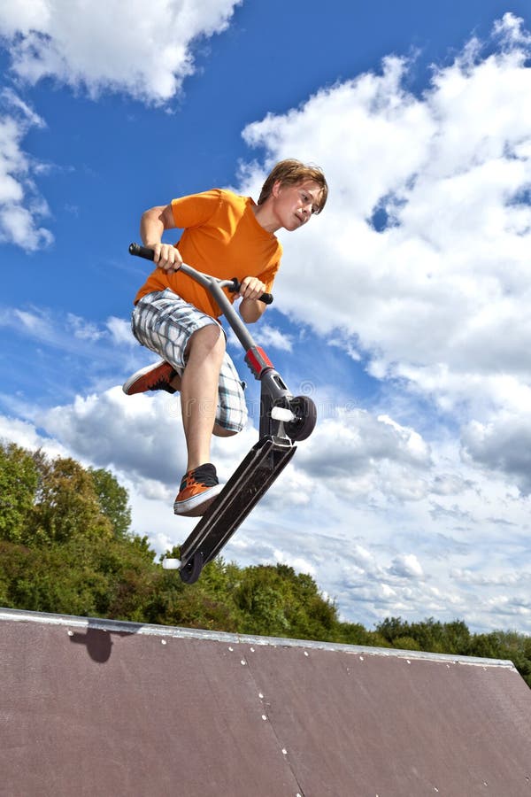 Boy Jumping Over a Ramp with His Stock Image - Image of caucasian ...