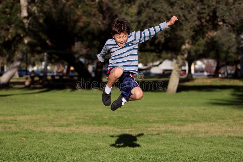 Boy jumping in park stock image. Image of jump, park - 28383591