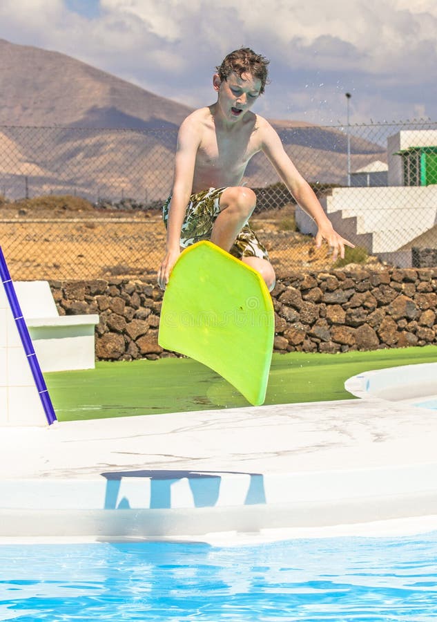 Boy jumping in the pool stock photo. Image of beauty - 38388498