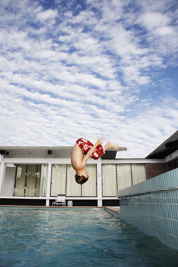 Boy 7-9 Jumping into Pool Side View Stock Photo - Image of diving ...