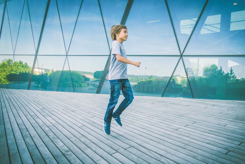 Boy Jumping and Running in the City Stock Image - Image of child ...