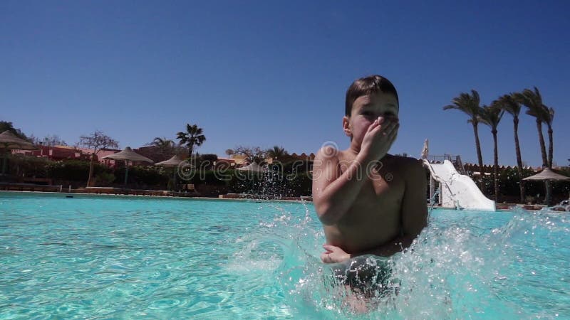 Boy Jumping in Swimming Pool with Splash, Slow Motion Stock Footage ...
