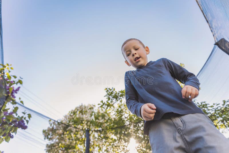Boy Jumping on a Trampoline Stock Photo - Image of outdoor, baby: 254338112