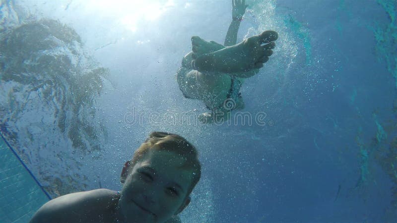 The Boy Jumps after the Girl from the Edge of the Pool. Shooting Under ...