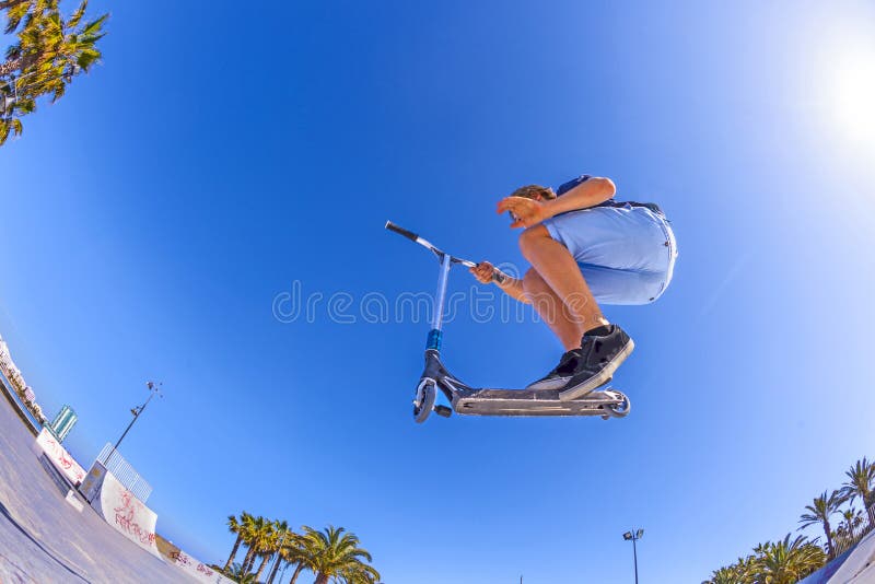 Boy Jumps with His Scooter at a Skate Park Stock Image - Image of ...