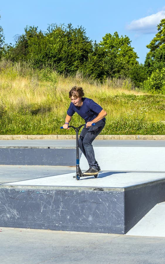 Boy Jumps with His Scooter at a Skate Park Stock Image - Image of ride ...