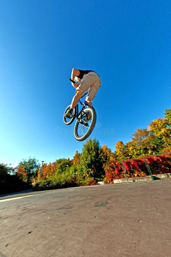 Boy Jumps with Scooter at the Skate Park Over a Ramp Stock Image ...