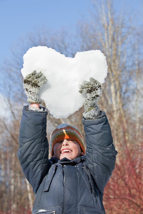 Boy Keeps in Hands Hearts from Snow Over Head Stock Photo - Image of ...