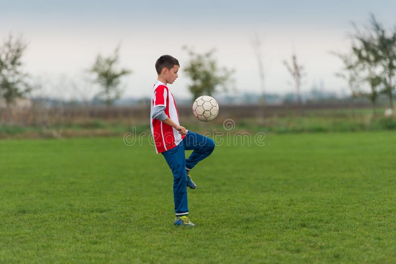Boy kicking football stock photo. Image of grass, kick - 59166334
