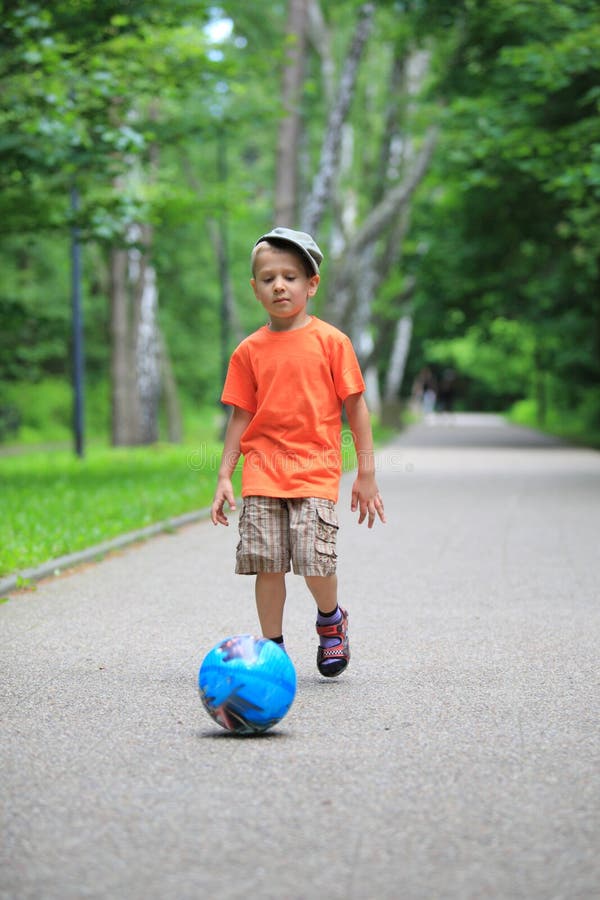 Boy Kicks the Ball in Park Outdoors Stock Image - Image of recreation ...