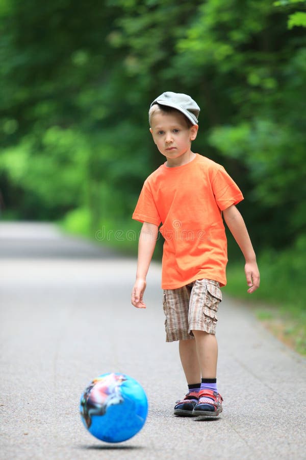 Boy Kicks the Ball in Park Outdoors Stock Photo - Image of playing ...