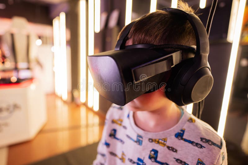 Boy Kid Playing Game Using Virtual Reality Headset and Gamepads in ...