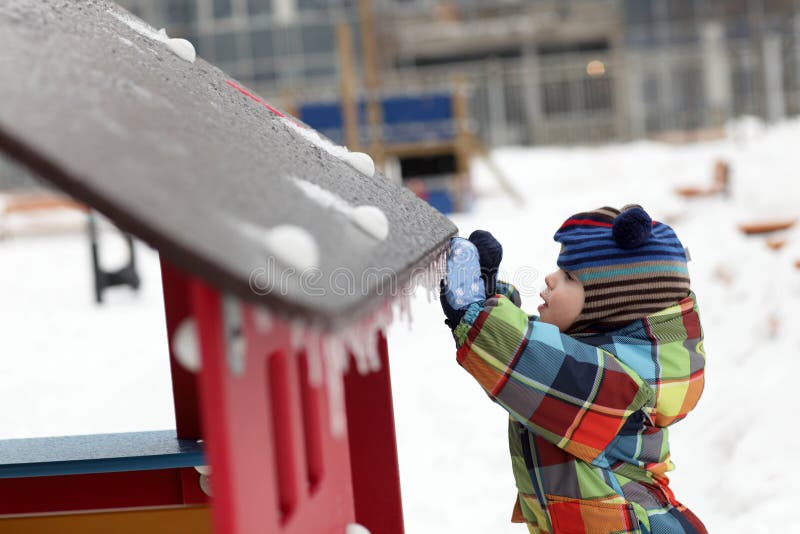 Boy knocks icicles stock image. Image of active, activity - 36657827