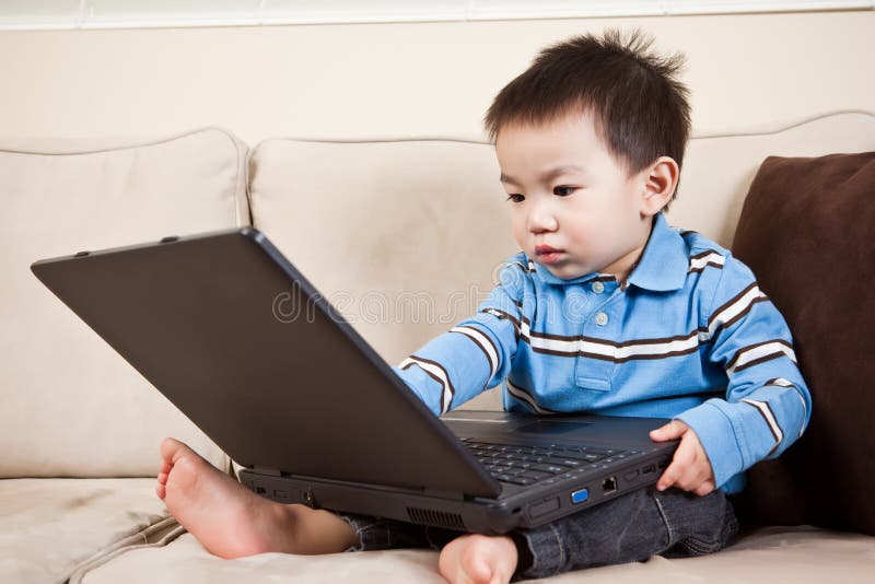 Playful Caucasian Boy Using Laptop Computer in Bed Stock Photo - Image ...