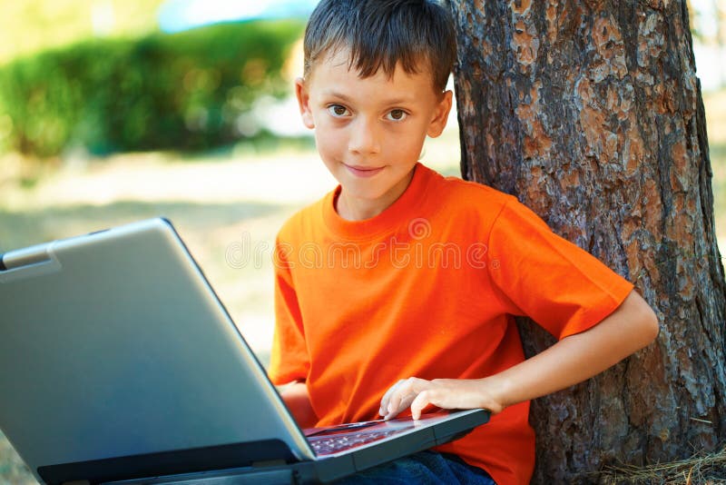 Boy with laptop stock photo. Image of outdoor, natural - 15263132