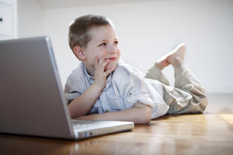 Boy with Laptop Computer Laying Down on the Floor Stock Photo - Image ...