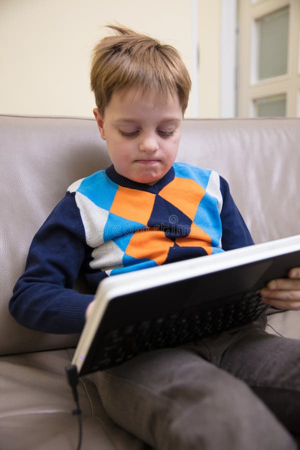 Boy with Laptop on Couch at Home Stock Image - Image of multitasking ...