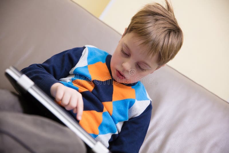Boy with Laptop on Couch at Home Stock Image - Image of cute, playing ...