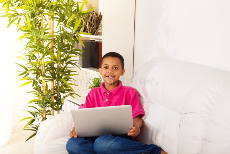 Boy with laptop stock photo. Image of indoors, black - 33483774
