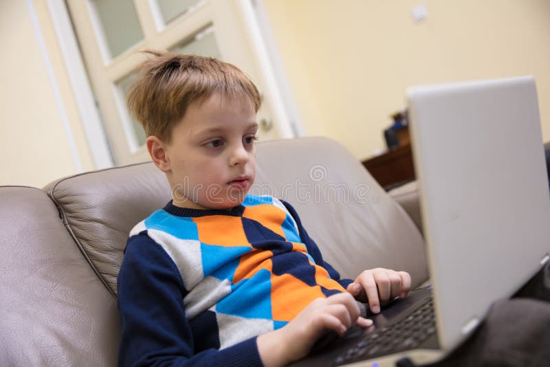 Boy with Laptop on Couch at Home Stock Image - Image of playing, enjoy ...