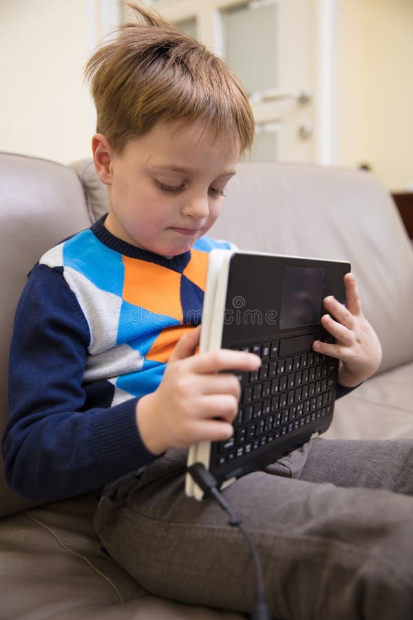 Boy with Laptop on Couch at Home Stock Photo - Image of computer, white ...
