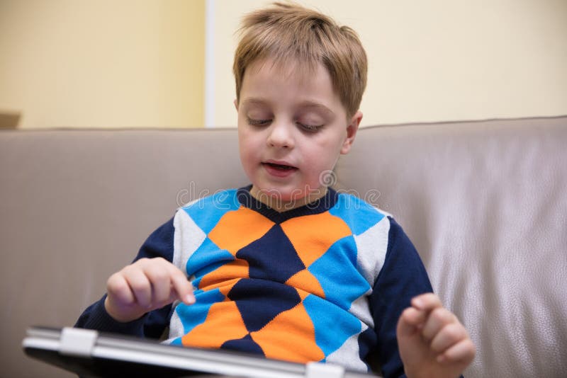 Boy with Laptop on Couch at Home Stock Image - Image of playful ...