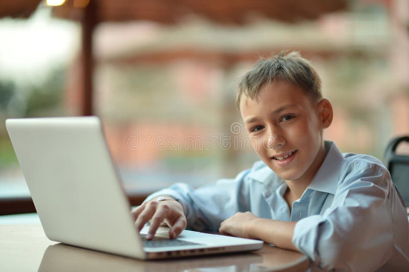 Boy with laptop on table stock image. Image of laptop - 56896327
