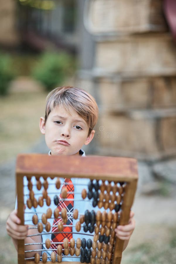 Boy with Large Abacus. Thoughtful Schoolboy Using a Maths Abacus ...