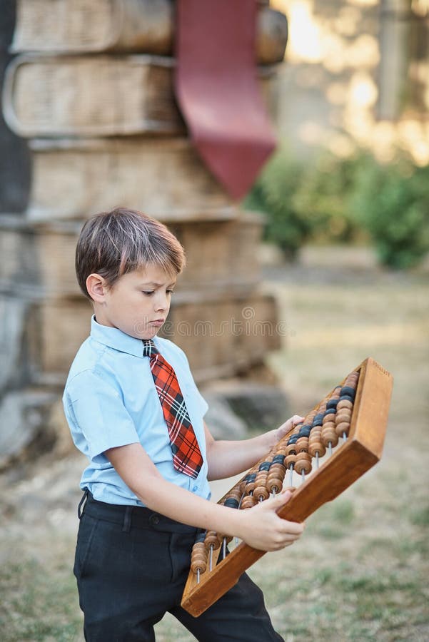 Boy with Large Abacus. Thoughtful Schoolboy Using a Maths Abacus ...
