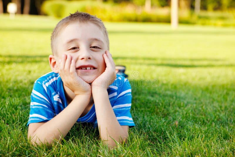 Boy laughing stock photo. Image of looking, grass, cute - 15618602