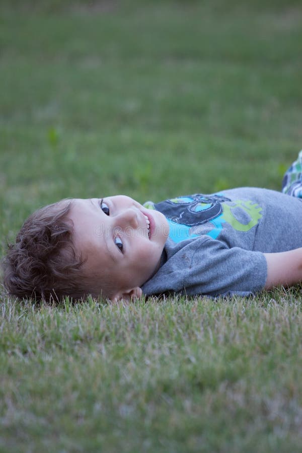 Boy on lawn stock photo. Image of looking, happy, child - 44011744