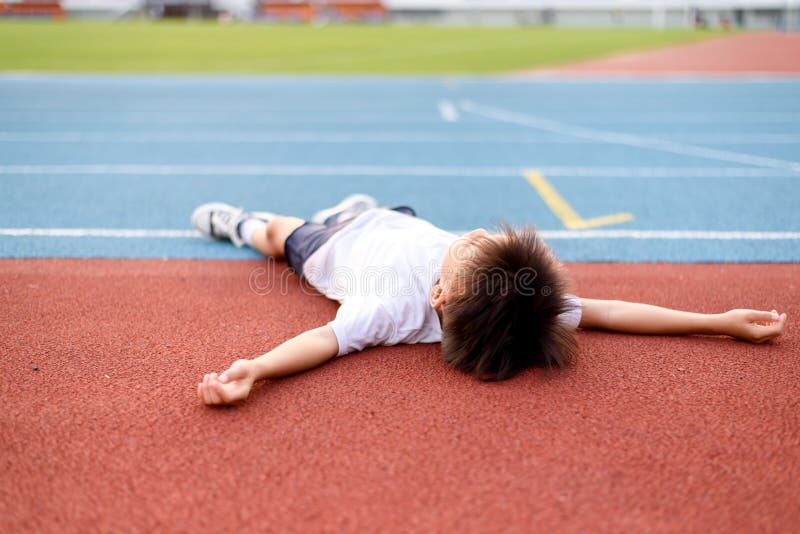 Boy Lay on the Running Track Stock Image - Image of field, summer: 72484919