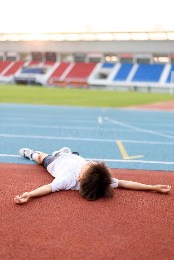 Boy Lay on the Running Track Stock Photo - Image of competition, asian ...